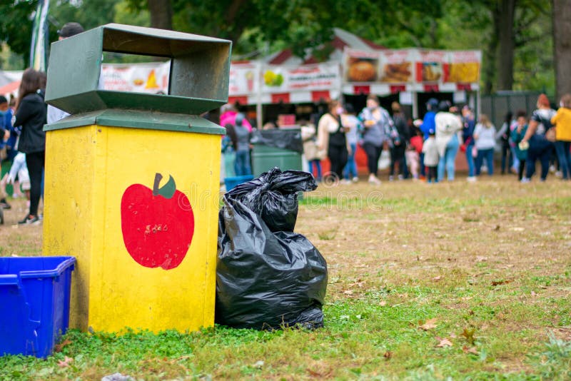 A Trash Can at a Fair with an Apple Painted on it Stock Photo - Image ...