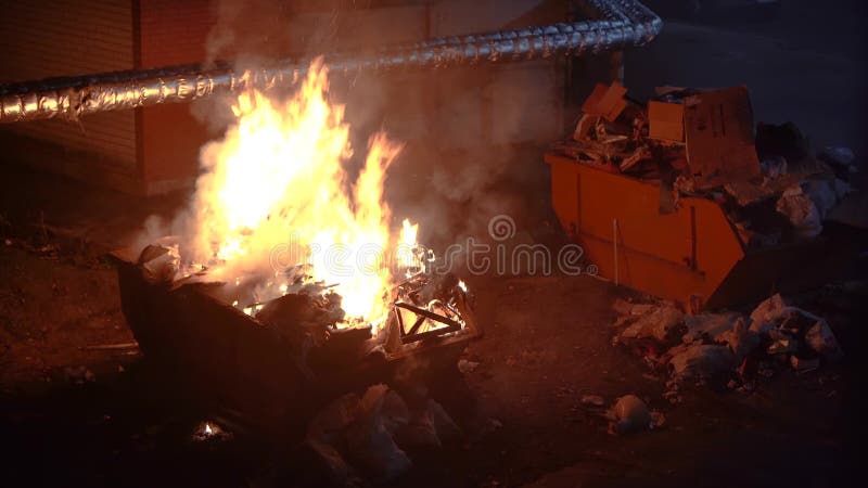Trash cans burn at night stock footage. Video of garbage - 178389314