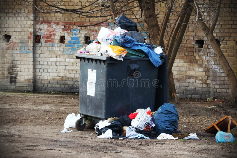 Trash Container Full of Bags and Clothes Standing Near Tree Stock Image ...