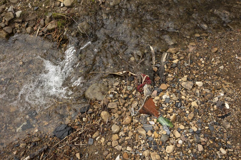 Trash Mixed with Rocks Along a Small Stream of Water Stock Image ...