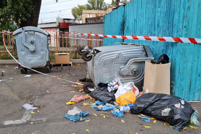 Trash in Overloaded Inverted Garbage Bins on City Street. Ecological ...