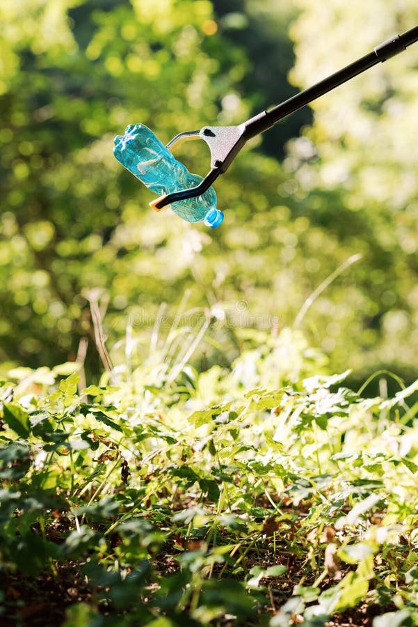 Trash Picker with Plastic Bottle Stock Image - Image of nature, grass ...