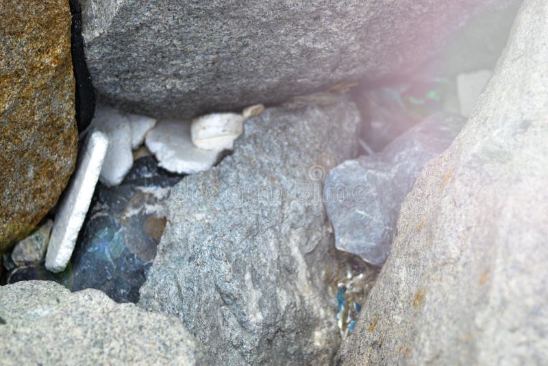 Trash in the rock stock photo. Image of environment - 163360286