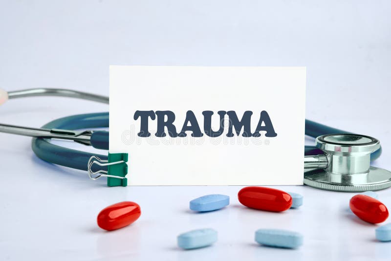 TRAUMA Written on a White Business Card on a Light Background Stock ...