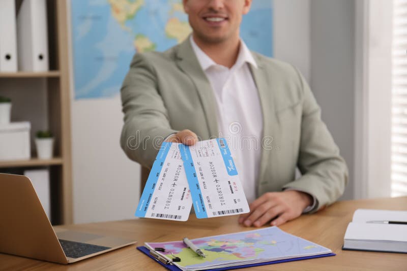 Travel Agent with Tickets at Table in Office Stock Photo - Image of ...
