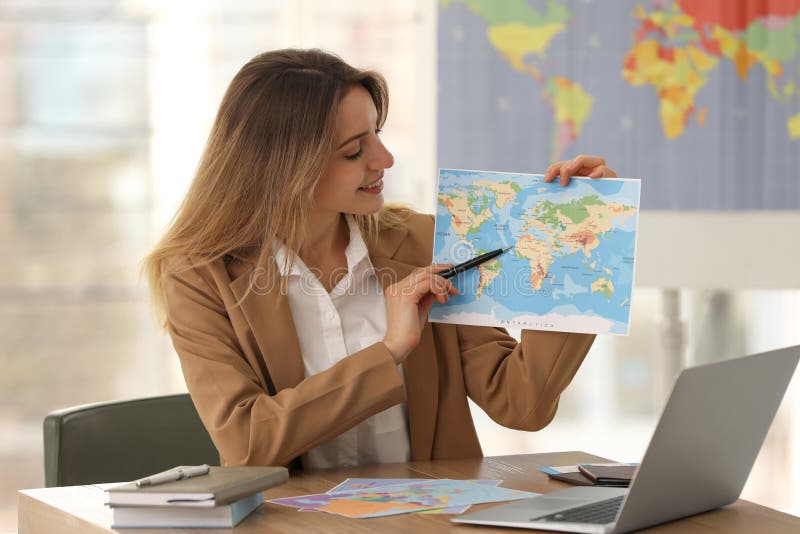 Travel Agent with World Map at Table in Office Stock Photo - Image of ...