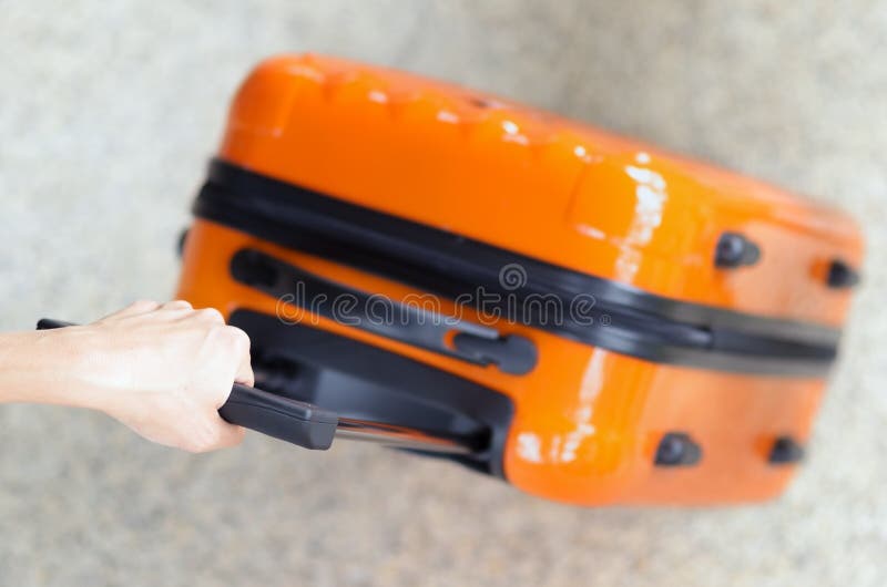 Woman Holds Orange Suitcase in Hand Stock Photo - Image of flying ...