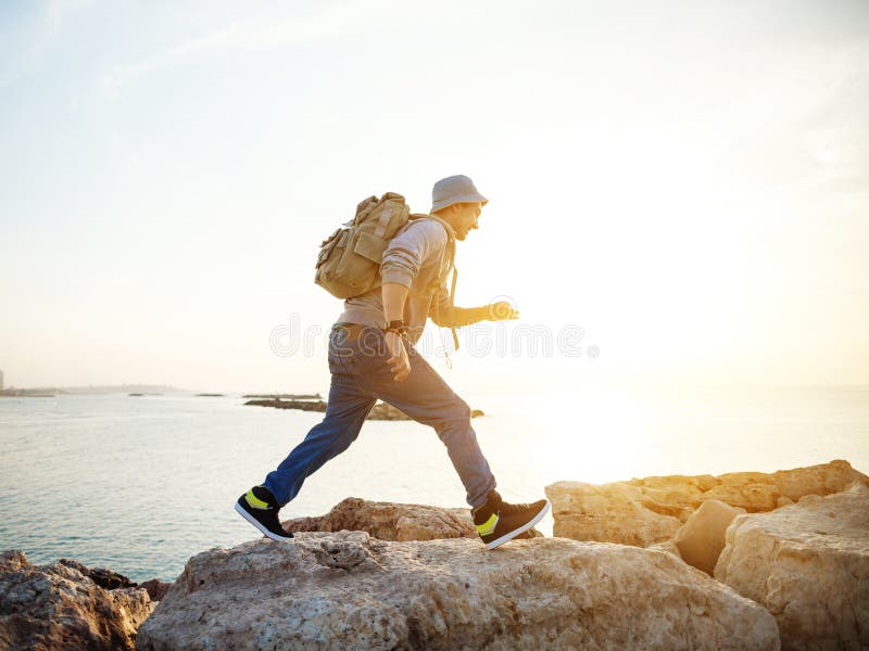 Traveler with Backpack Running Over Rocks Stock Image - Image of rush ...