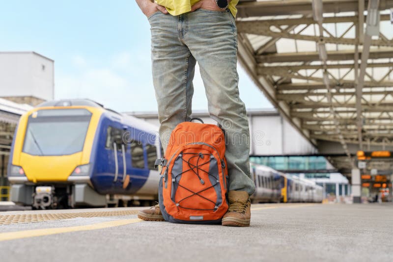 Traveler with Backpack Waiting for a Train at the Train Station. Travel ...