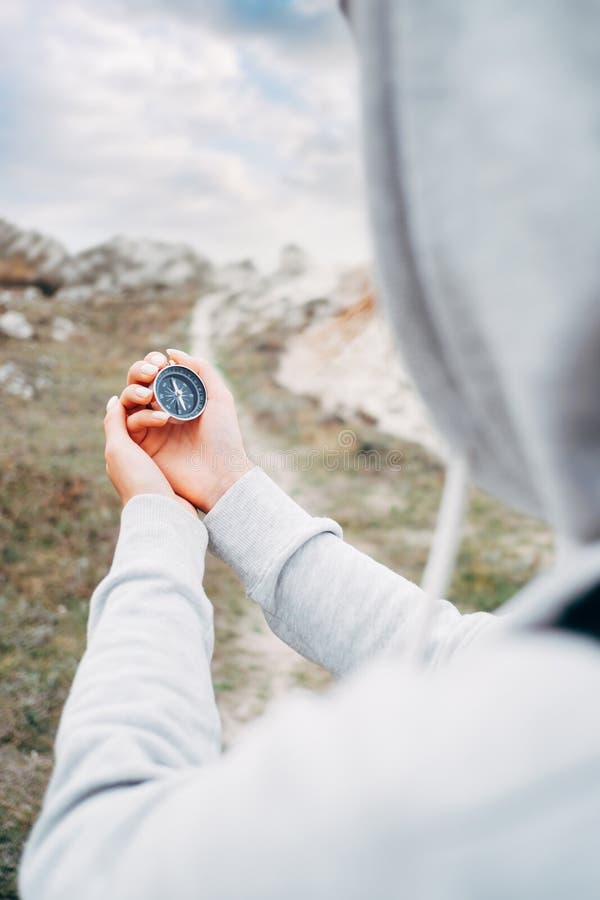 Traveler with a Compass is Looking for the Direction of His Path. Stock ...