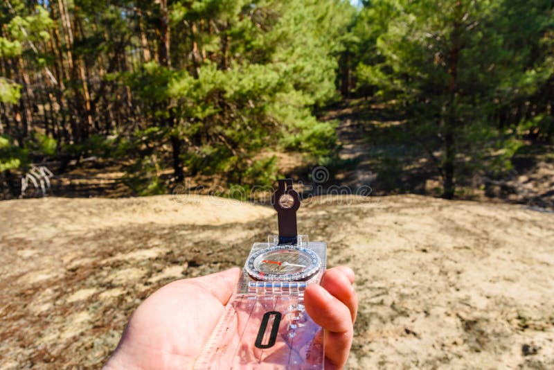 Traveler Looking for the Right Way in a Forest with Compass Stock Photo ...