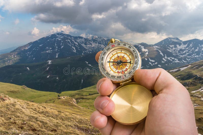 Traveler Man with Compass Seeking a Right Way in the Mountains Stock ...