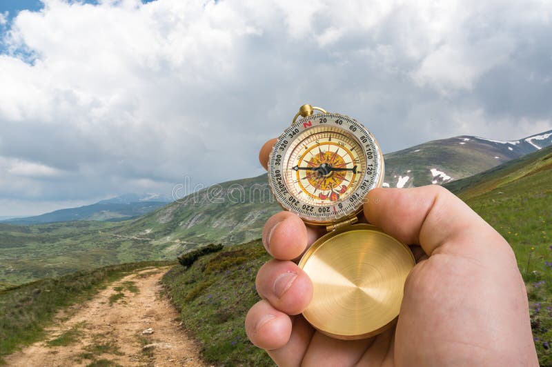 Traveler Man with Compass Seeking a Right Way in the Mountains Stock ...