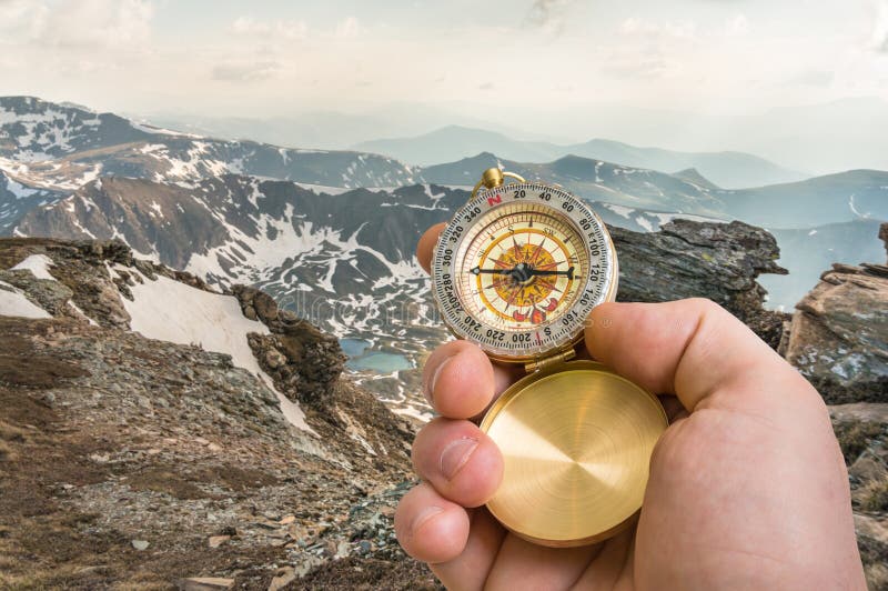 Traveler Man with Compass Seeking a Right Way in the Mountains Stock ...