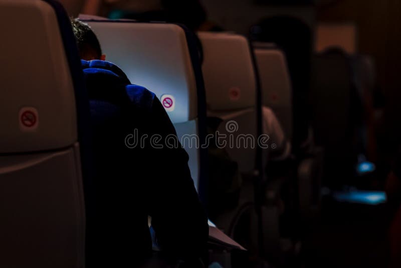 Traveler Reading Something Inflight on the Plane with Dark / Low Light ...