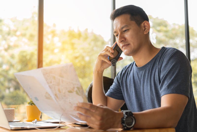 Traveler is Using Phone and Planning Vacation Using the World Map Stock ...