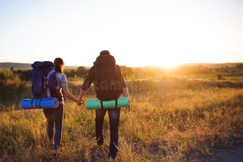 Travelers with Backpack Walking in Sunset. Back View. Stock Image ...