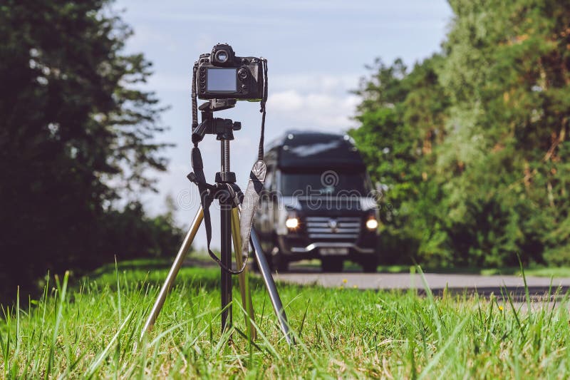 Traveling with a Camera on a Tripod. Background of Nature and Road with ...