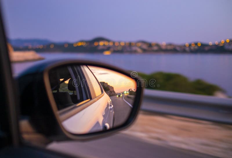 Traveling by Car Along Beautiful Coast at Night. Reflection of Sunset ...
