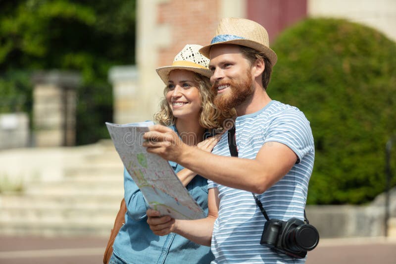 Traveling Couple Searching for Their Next Destination on Map Stock ...