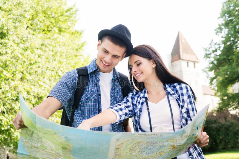 Traveling Couple Searching for Their Next Destination with a Map Stock ...