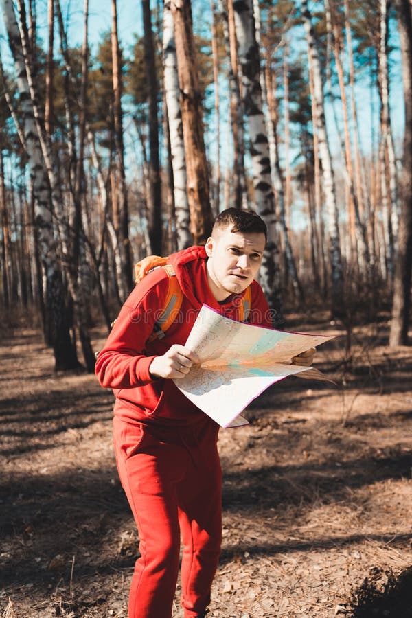 Traveling Man with Map in Woods. Side View of Man with Backpack Reading ...