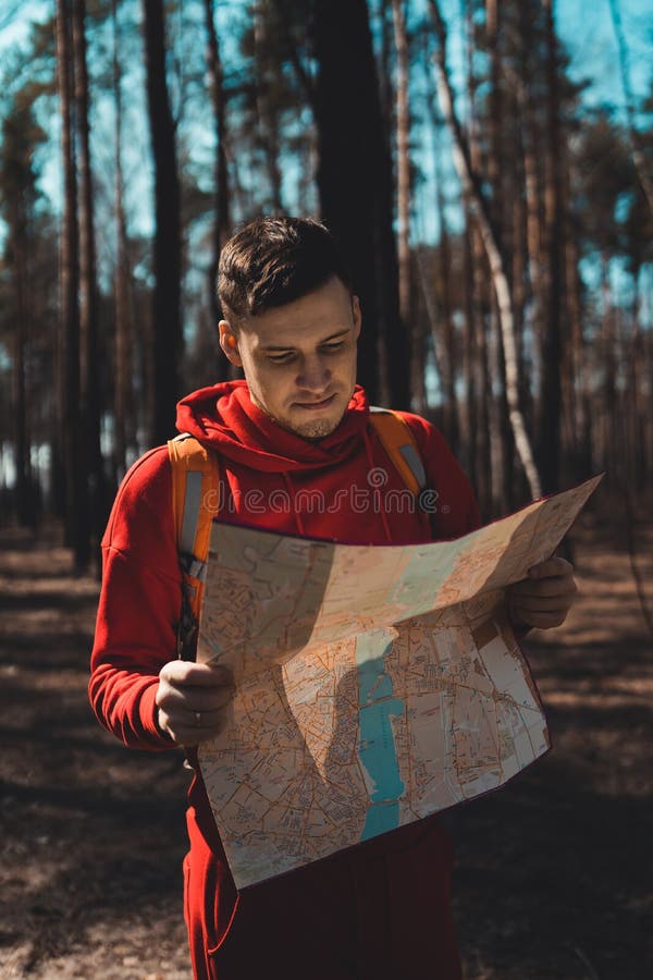 Traveling Man with Map in Woods. Side View of Man with Backpack Reading ...