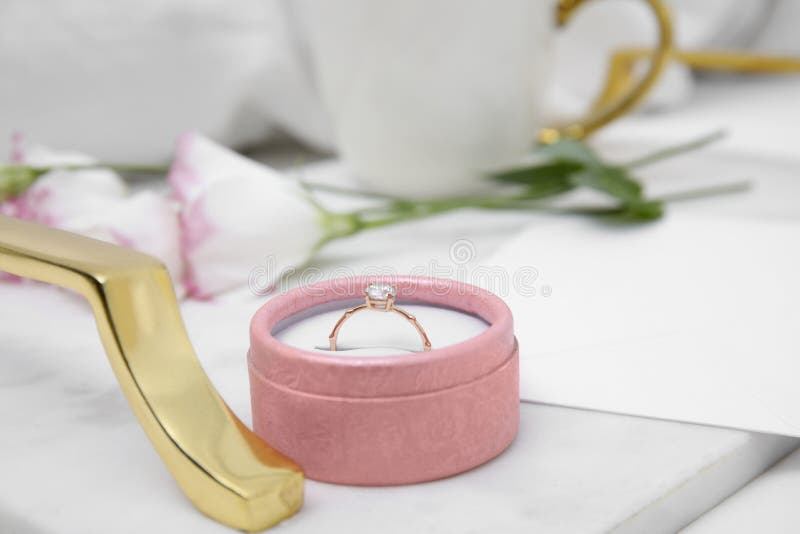 Tray with Beautiful Engagement Ring in Box on White Bed, Closeup Stock ...