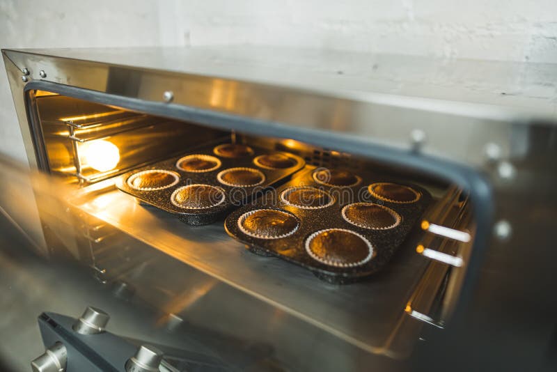 Tray of Chocolate Cupcakes Baking in Open Oven with Light on ...