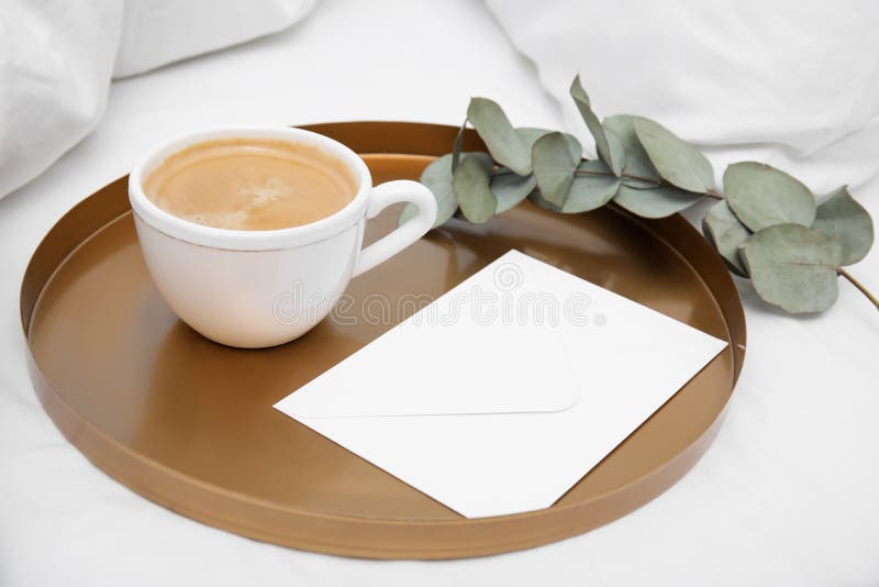 Tray with Cup of Coffee, Envelope and Eucalyptus Branch on White Bed ...