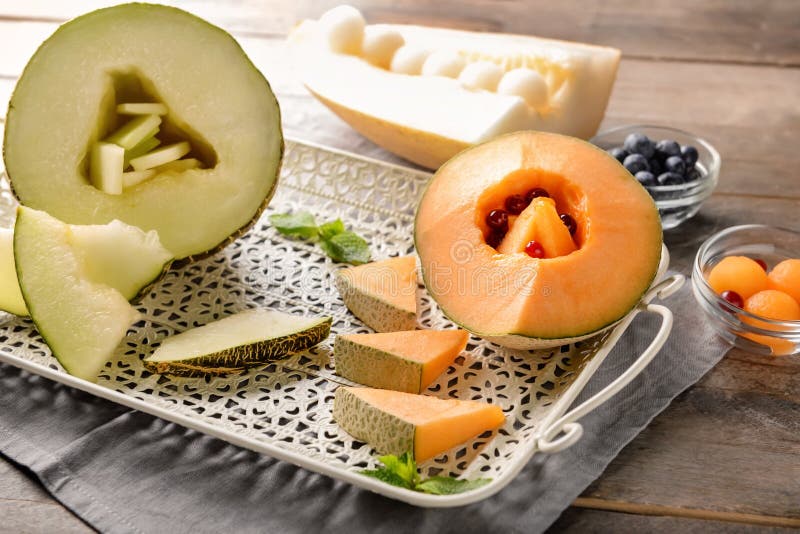 Tray with Delicious Melon on Wooden Table Stock Photo - Image of fruit ...