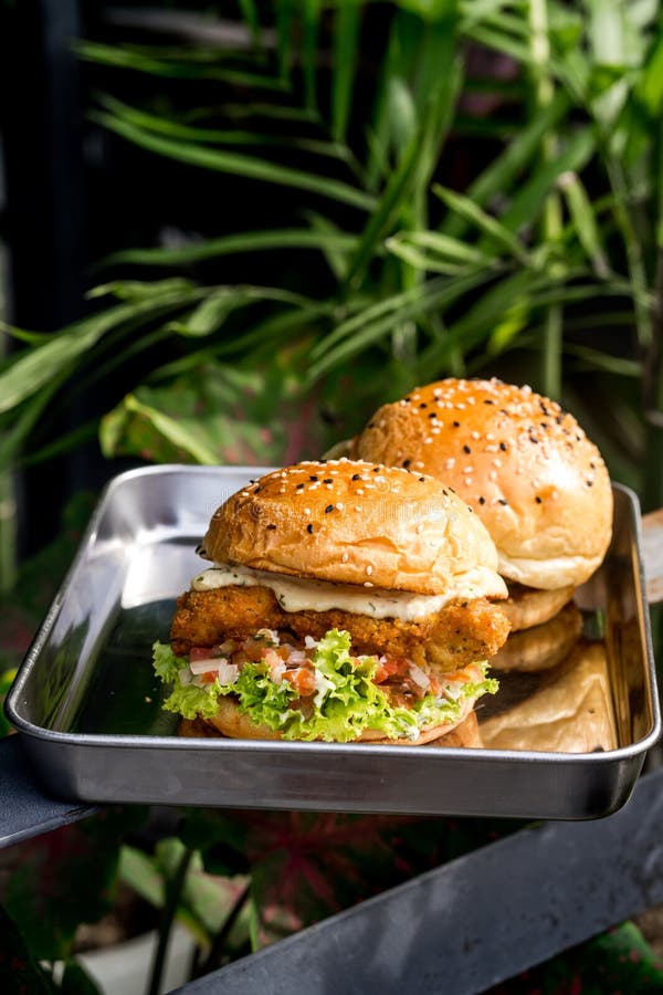 A Tray of Two Burgers on the Side of a Balcony Stock Image - Image of ...