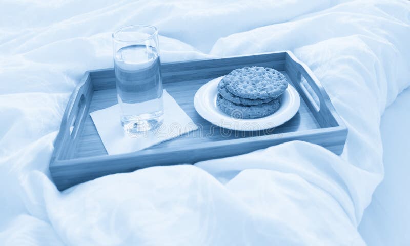 Tray with Water and Crackers Dbreakfast on a Bed Stock Image - Image of ...