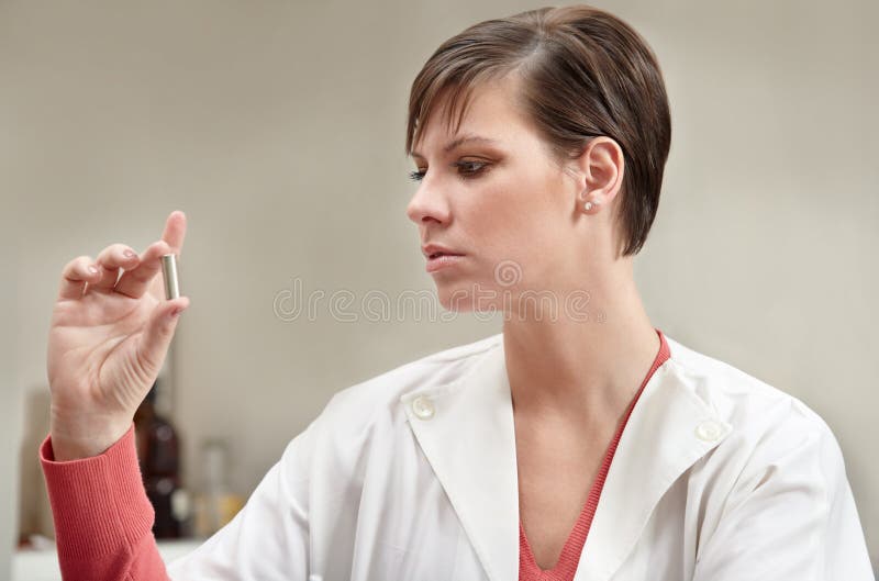 Treating the Evidence with Care. a Forensic Technician Holding Up a ...