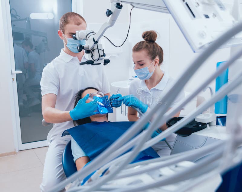 Treatment of Root Canals Under a Microscope, Work with an Assistant ...