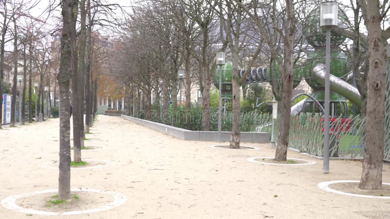 Tree-Lined Pathway in a Paris Park Featuring Sculptures and Lush ...