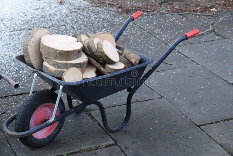 Tree Logs in Wheel Barrow stock image. Image of rawmaterial - 138765279
