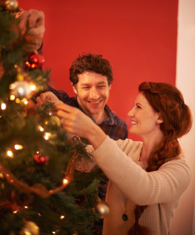 The Tree Looks Awesome. an Affectionate Young Couple Decorating the ...