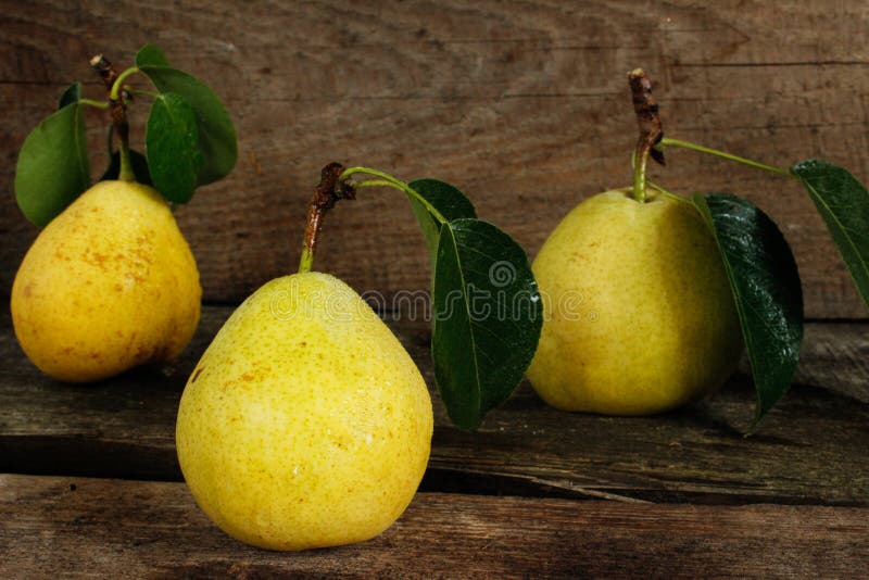 Three Pears with Leaves on a Wooden Surface Stock Photo - Image of ...