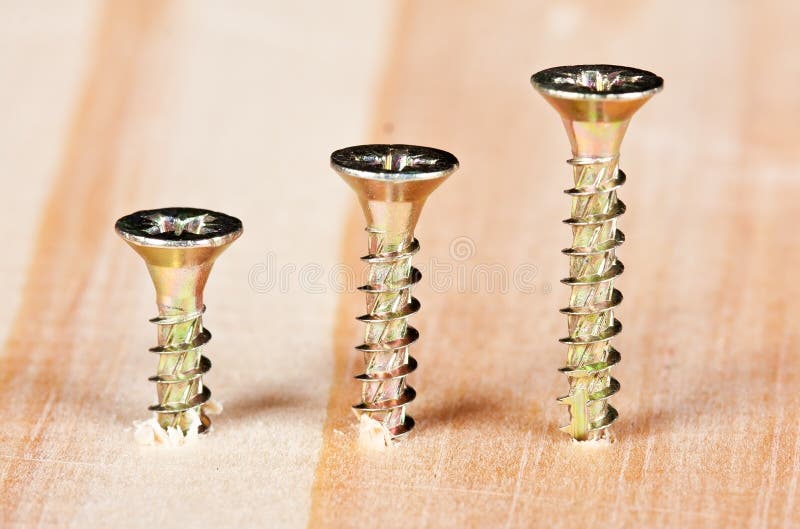 Tree Screws in a Wooden Surface Stock Photo - Image of brown, iron ...