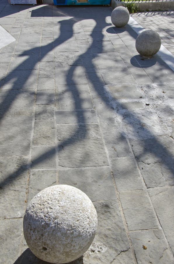 Tree Shadow on Street Pavement with Round Decorative Stone Sphere Stock ...