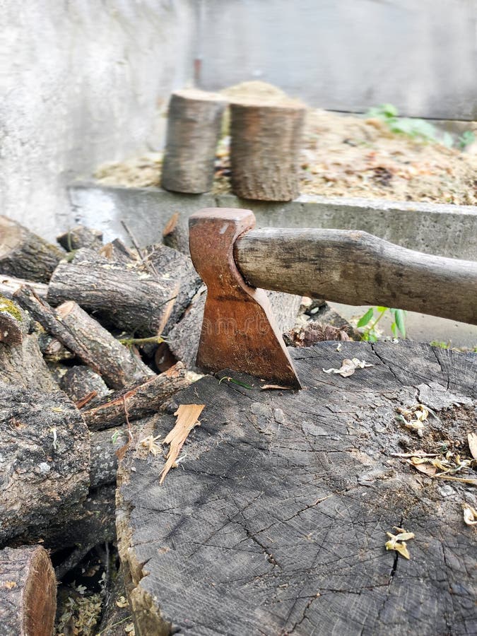 In a Tree Stump There is an Ax for Cutting Down a Forest, an Ax with a ...