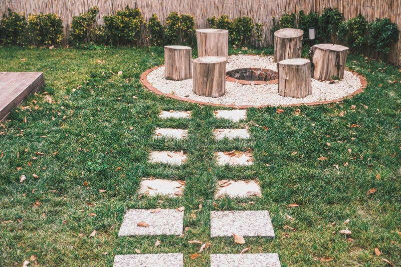 Tree Stumps Around Fire Pit with Smoke Rising from the Burning Logs ...