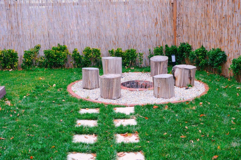 Tree Stumps Around Fire Pit with Smoke Rising from the Burning Logs ...