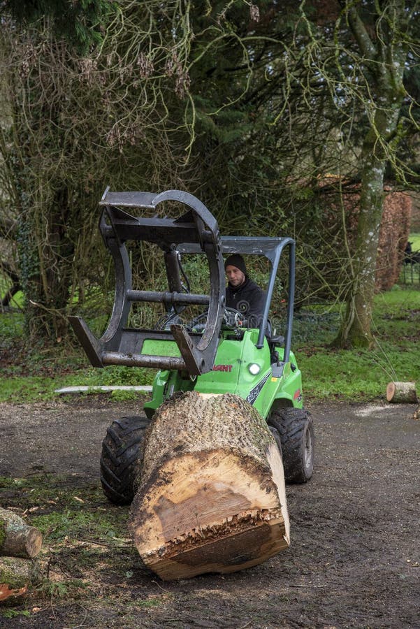 Tree Trunk Being Moved Using a Small Tractor and Grab Editorial Image ...