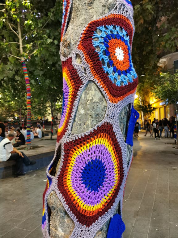 Tree Trunk in a Knitted Cover Made of Multi-colored Patterns. Editorial ...