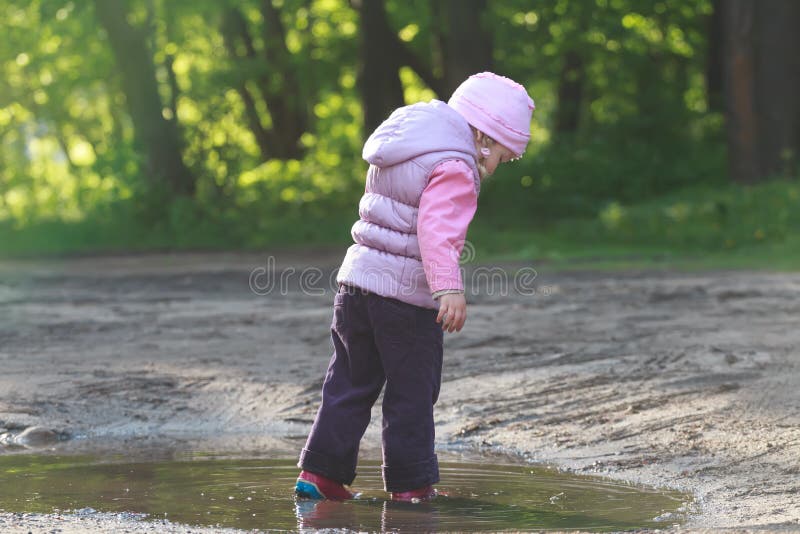 Tree Years Old Girl Exploring Summer Puddle In Red Gums Stock Photo ...