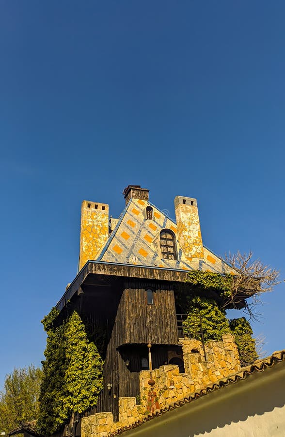 Treehouse with a Sloping Roof and Chimneys and Small Windows Stock ...