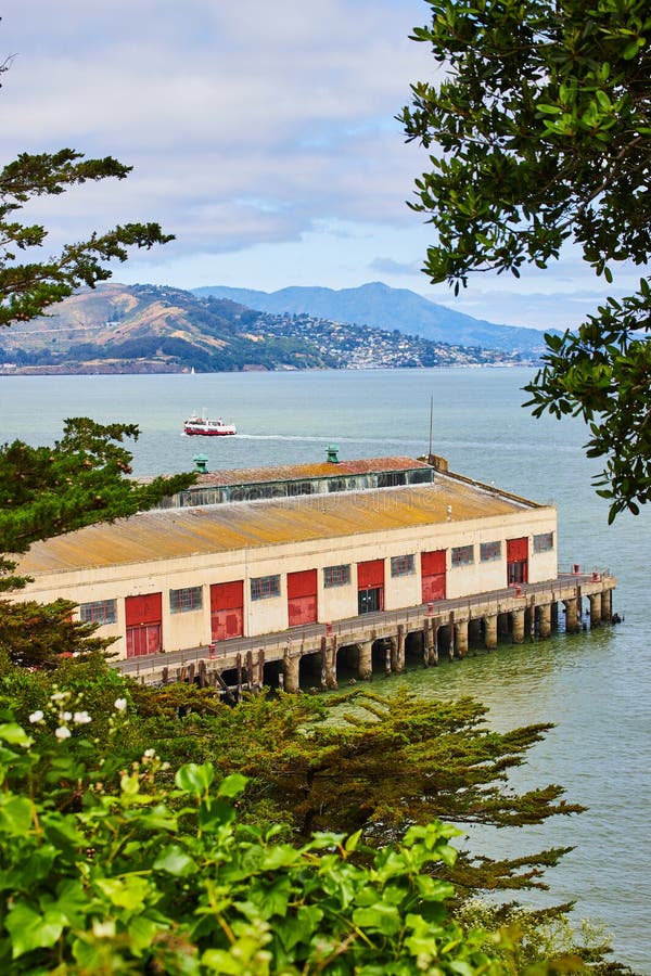 Trees Framing a Warehouse on a Dock with a Tour Boat on San Francisco ...