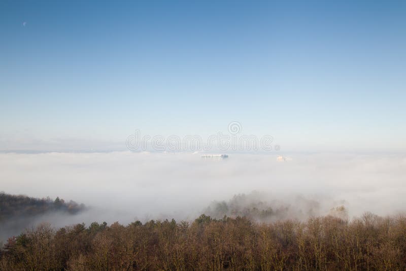 Several Buildings in the Fog with Blue Sky Stock Photo - Image of mist ...